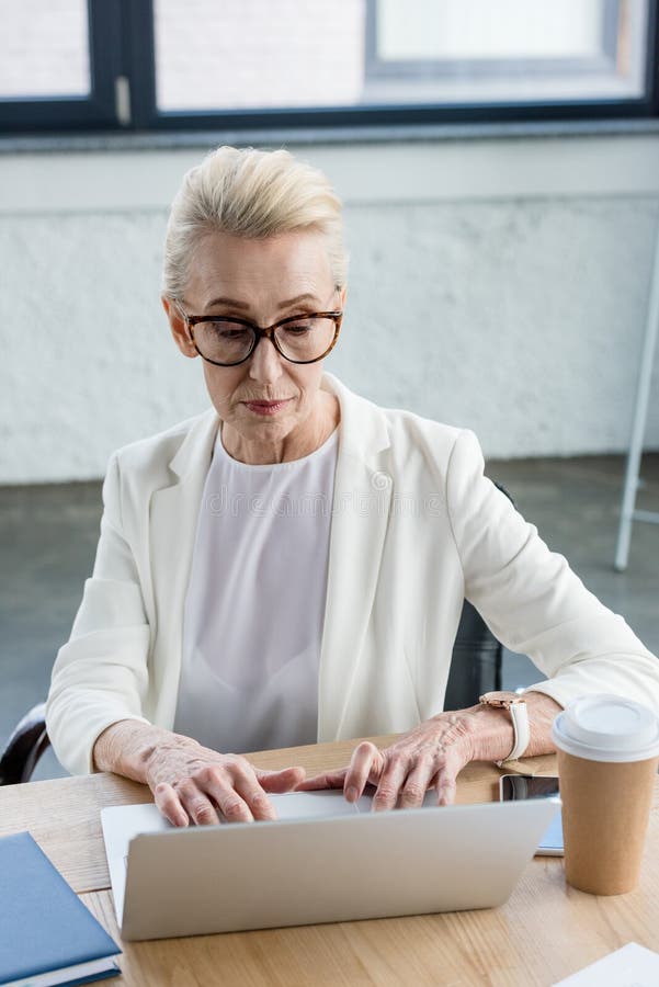 Focused Businesswoman in Eyeglasses Using Laptop Stock Image - Image of ...