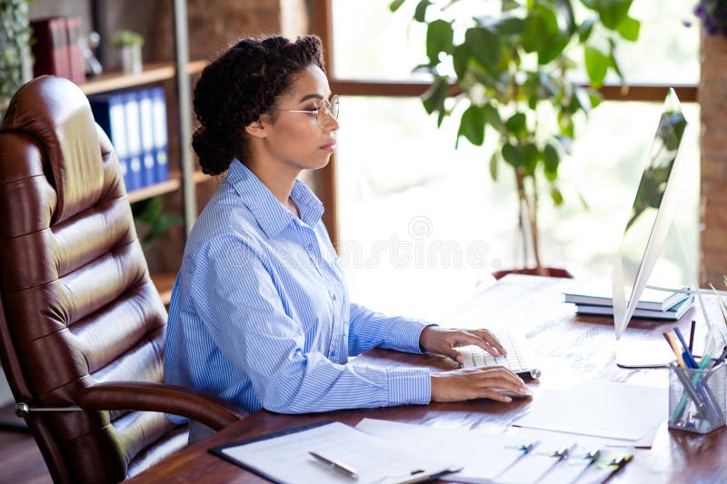 Focused Businesswoman Working on Computer in Modern Office Setting ...