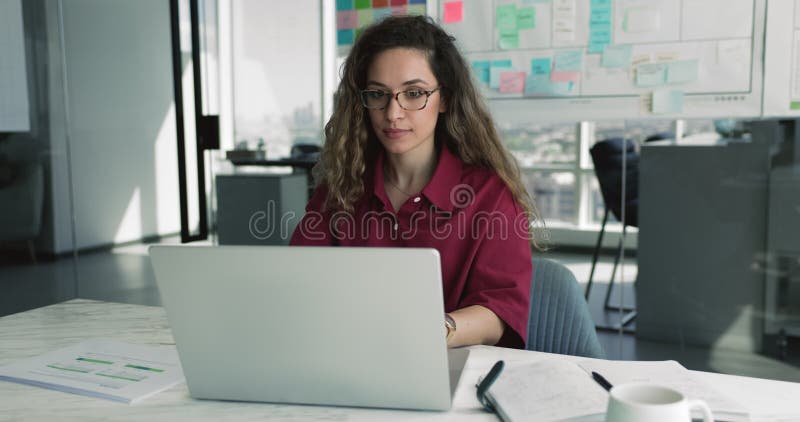 Focused Businesswoman Working on Laptop Seated at Desk in Office Stock ...
