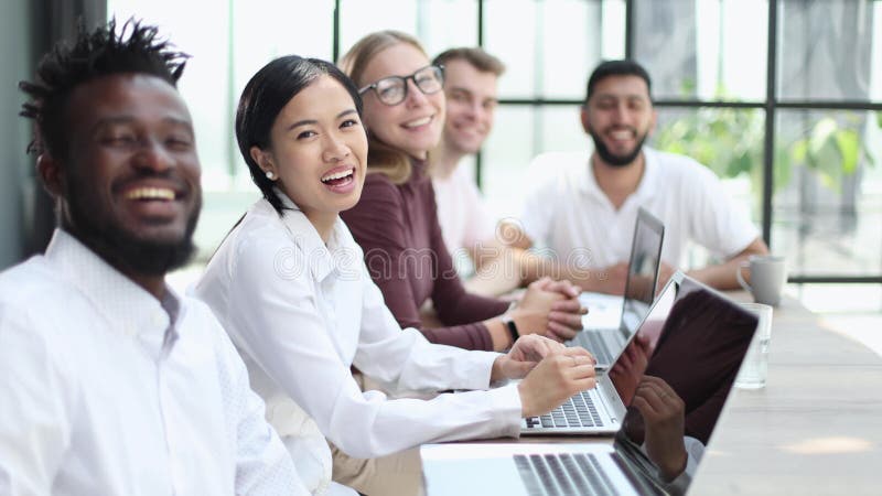 Focused Call Centre Operators with Headphones Working with Computers at ...