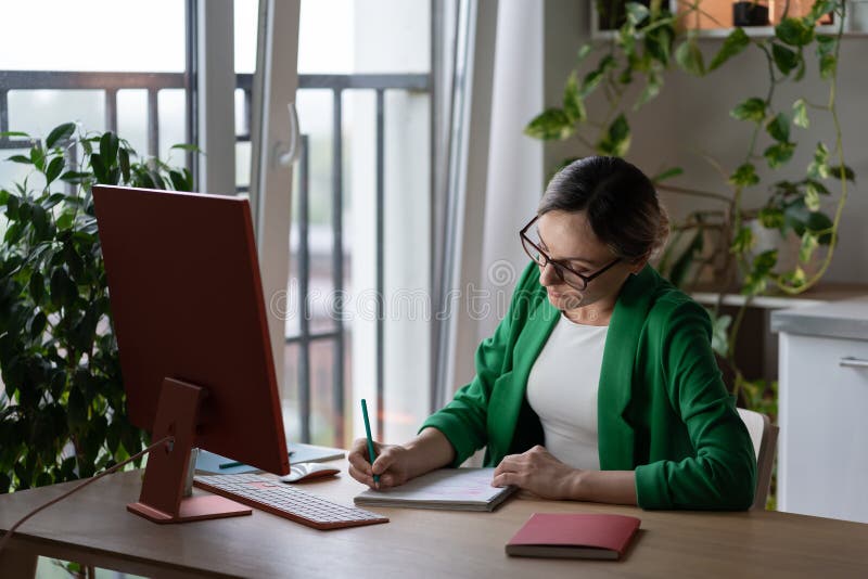 Focused Caucasian Woman Tutor or Teacher Making Notes in Notebook Sits ...