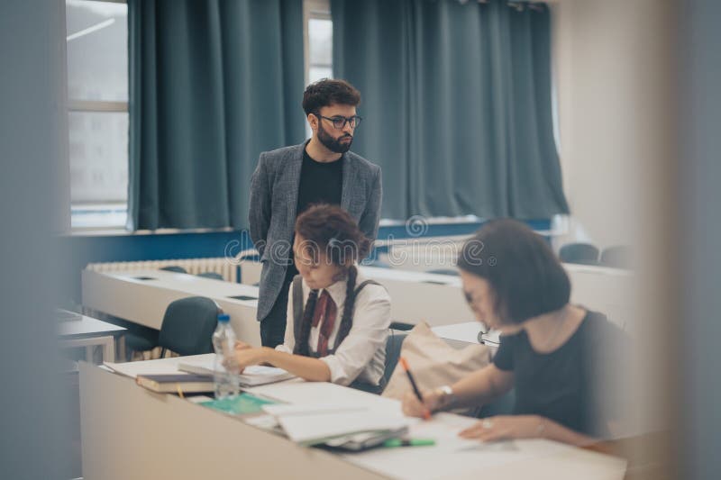 Focused Classroom Environment with Students Studying at Desks with ...