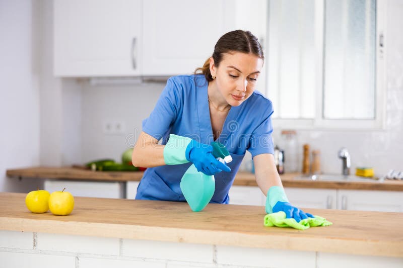 Focused Cleaning Service Female Worker at Kitchen Stock Photo - Image ...