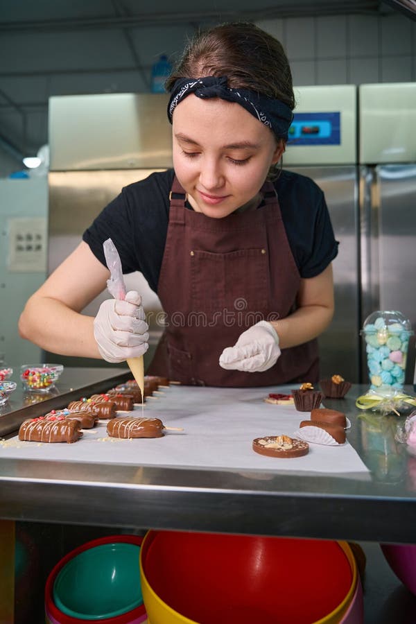 Focused Confectioner is Decorating Batch of Cakesicles on Kitchen ...