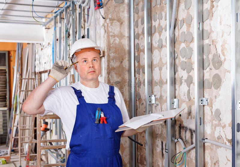 Focused Construction Worker Inspecting Room and Planning Upcoming ...