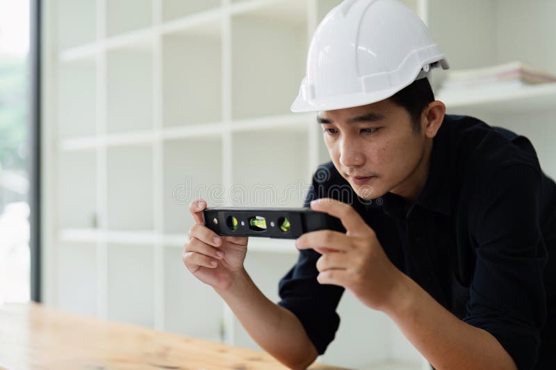 Focused Construction Worker Using a Level Tool for Precision ...