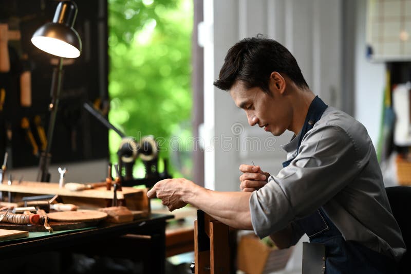 Focused Craftsman Meticulously Stitching Leather with a Needle and ...