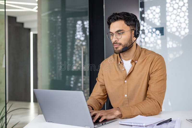 Focused Customer Service Representative Working on Laptop with Headset ...