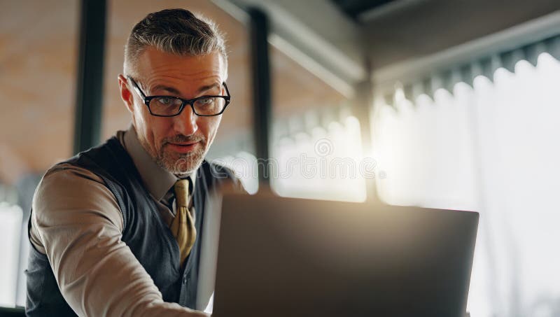 A Focused and Dedicated Professional Working on a Laptop in a Modern ...