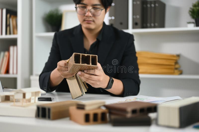 Focused Designer or Architect Examining a Building Material or ...