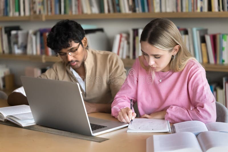 Focused Diverse Couple of College Classmates Watching Learning Webinar ...