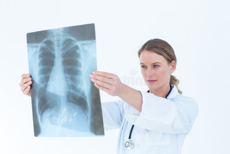 Focused Doctor Looking At Xray Stock Image - Image of studio, woman ...