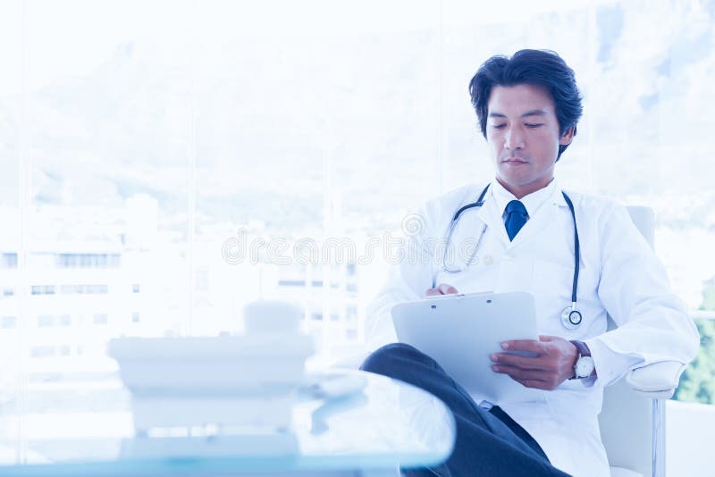 Focused Doctor Reading Over Notes Stock Photos - Free & Royalty-Free ...
