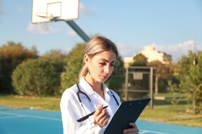 Focused Doctor Taking Notes in Open Air Stock Image - Image of ...