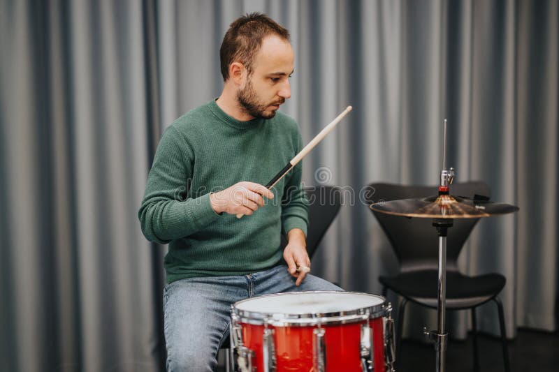 Focused Drummer Practicing on a Drum Set in Music Studio Environment ...