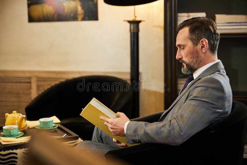 Focused Elegant Man Reading a Breathtaking Book Stock Photo - Image of ...