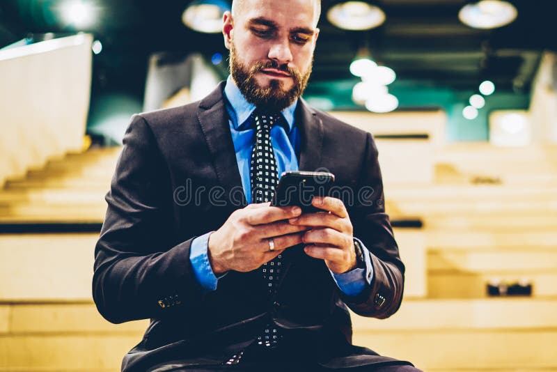 Focused Entrepreneur Watching Phone in Modern Building Stock Photo ...