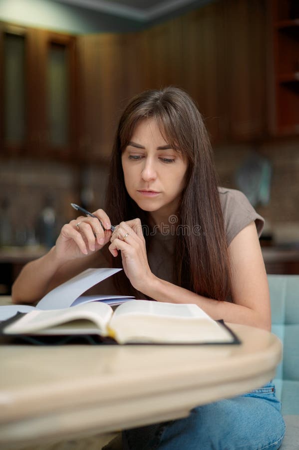 Focused Female Student Learning and Preparing Exam at Home, Reading ...