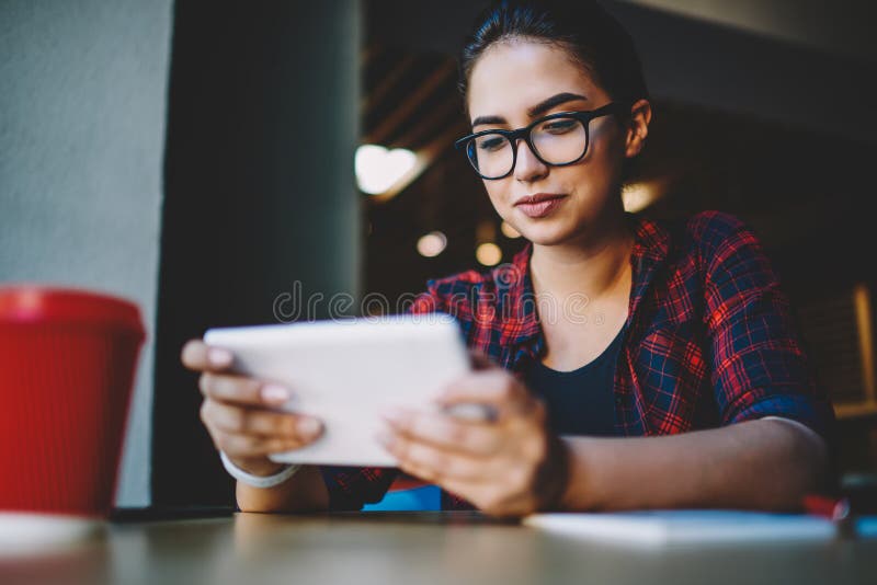 Focused Female Teleworker Using Tablet for Work in Cafe Stock Photo ...