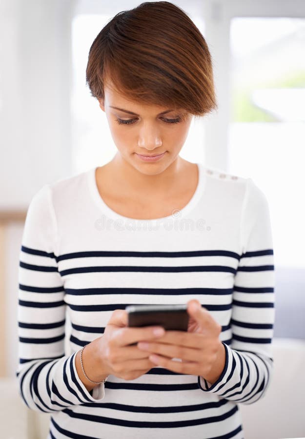 Focused On Finding The Perfect Reply An Attractive Young Woman Focused On Texting Stock Image