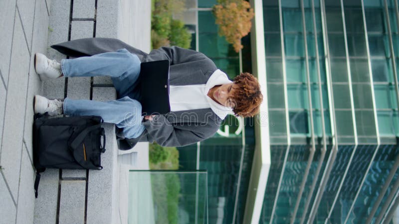 Focused Freelancer Typing Laptop on Street Vertical. University Student ...