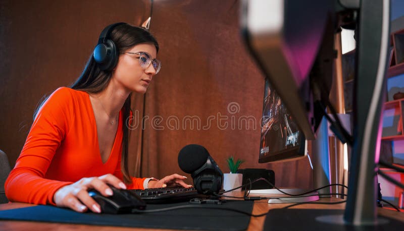 Focused on the Game Process. Young Beautiful Streamer is Indoors with ...