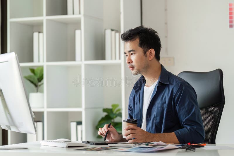 Focused Graphic Designer Working in Modern Design Studio with Digital Tools and Creative ...