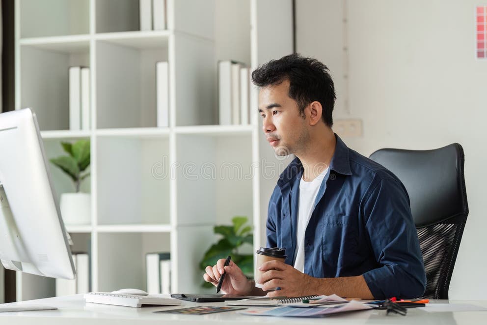 Focused Graphic Designer Working in Modern Design Studio with Digital Tools and Creative ...