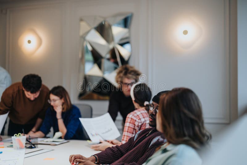 Focused Group of Professionals Collaborating in a Well-lit Office ...