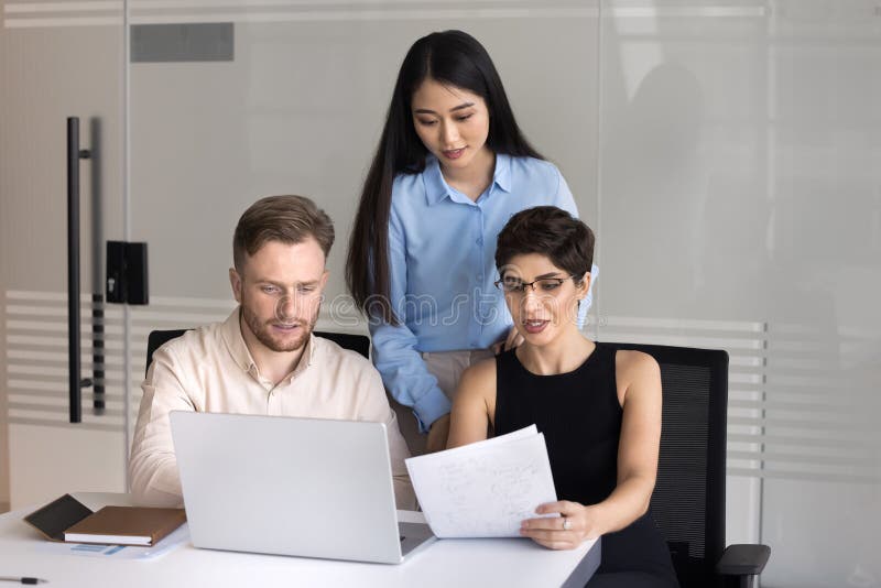 Focused Group Three Diverse Multiethnic Employees Do Paperwork Using ...