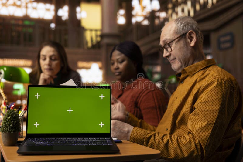 Focused Group of University Students Read Next To a Green Screen Device ...