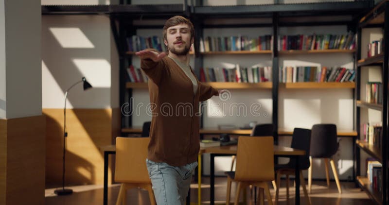 Focused Guy Student Stands in Warrior Pose during Yoga Class in Library ...