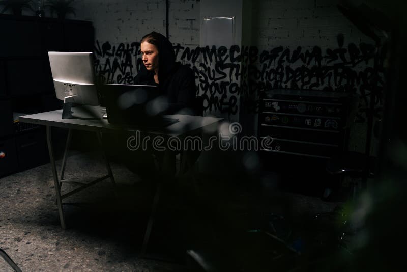 Focused Hacker Typing on Laptop in Dark Server Room Stock Image - Image ...