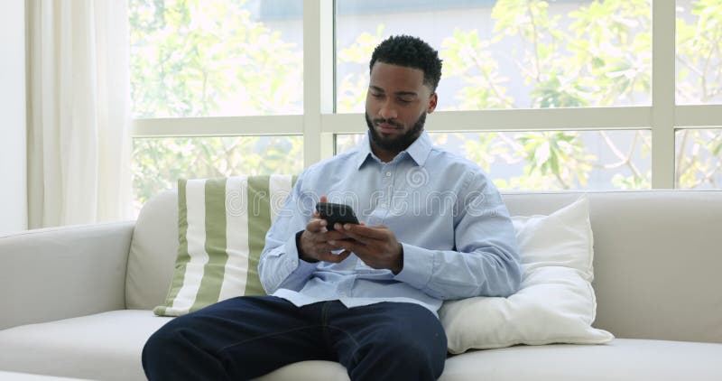 Focused Handsome African Guy Using Mobile Phone for Internet ...