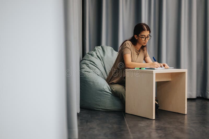 High School Student Studying Independently in a Relaxed Environment ...