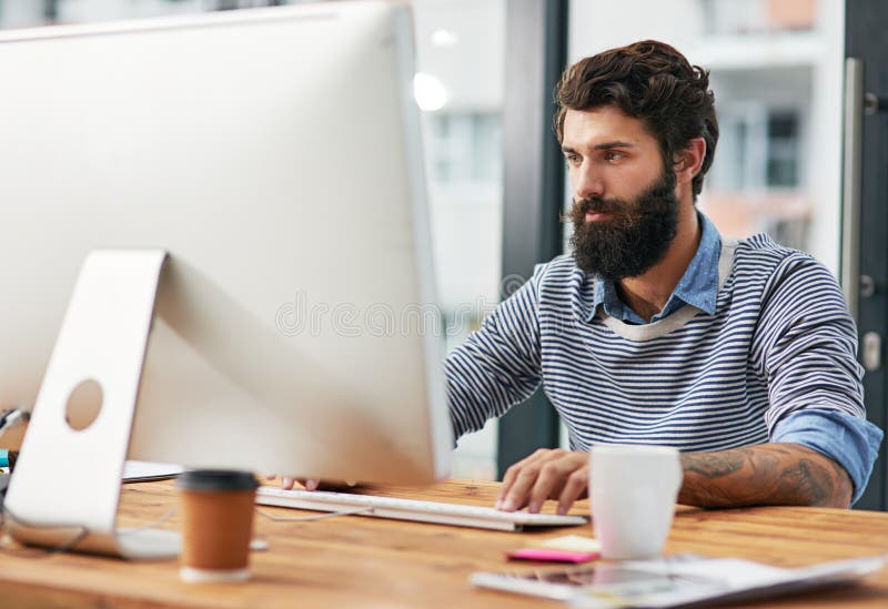 Focused on His Big Ambitions. a Young Creative Working on a Computer in ...