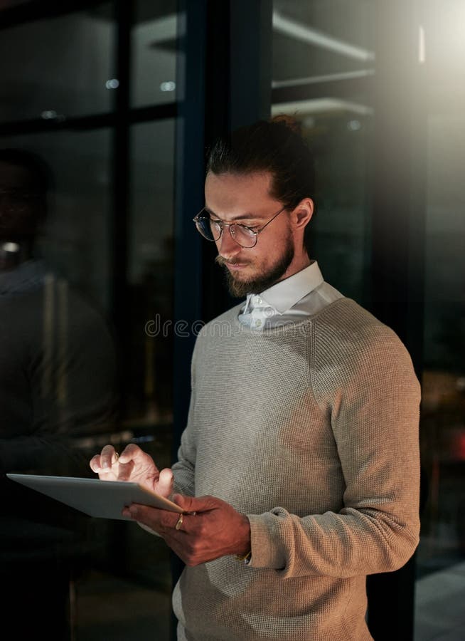 Focused on His Designs. a Handsome Young Designer Working Late in the ...