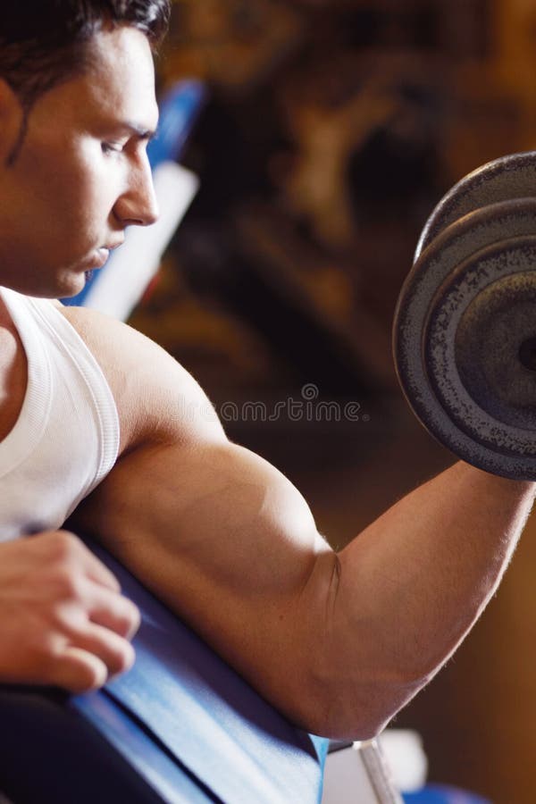 Focused on His Form. a Handsome Young Man Lifting Weights. Stock Image ...