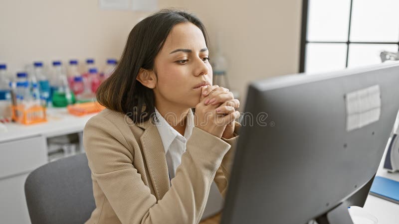 Focused Hispanic Woman Working Attentively on Computer in Modern ...