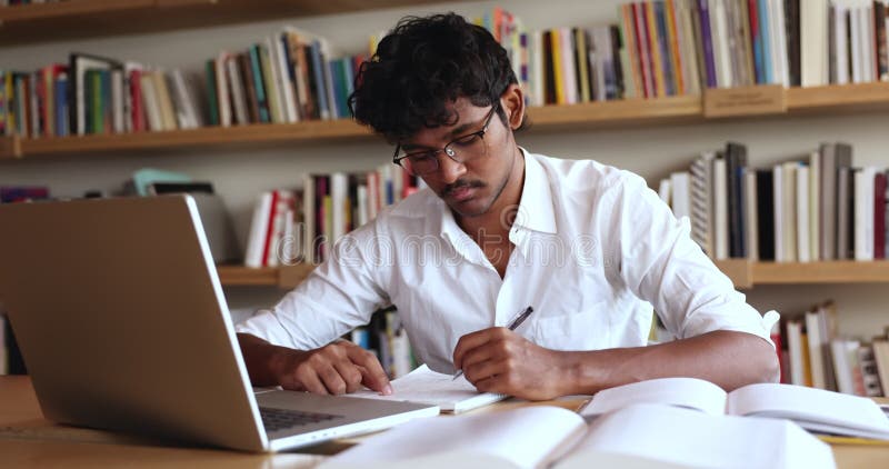 Focused Indian Student Guy Sit at Desk in Library Stock Footage - Video ...