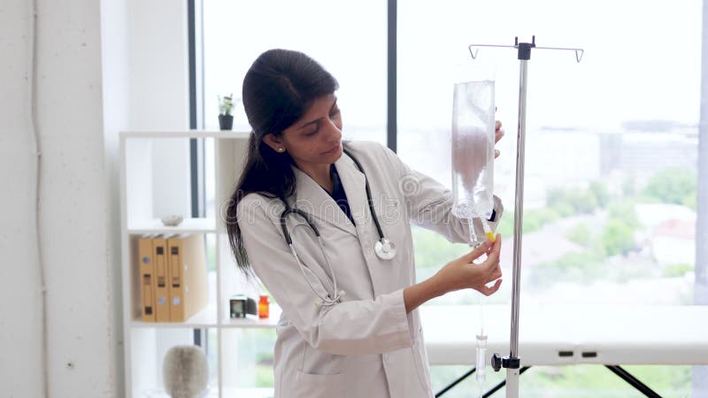 Focused Indian Woman Examining Drop Counter with Liquid Stock Footage ...