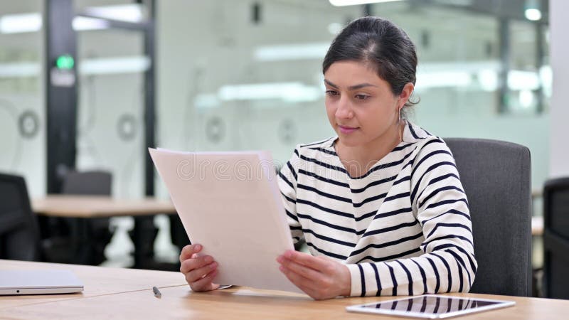 Focused Indian Woman Reading Documents at Work Stock Image - Image of ...