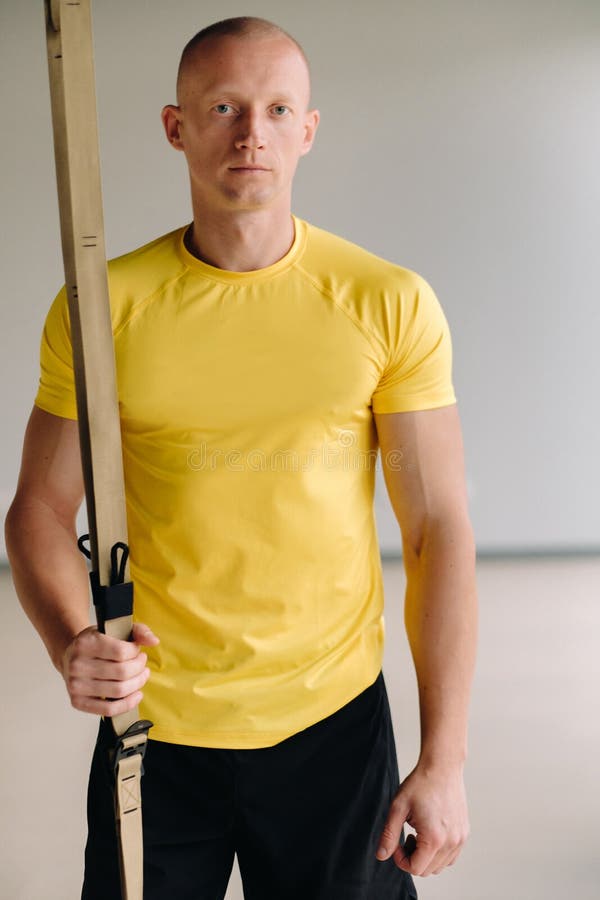A Focused Male Athlete Performing an Exercise on Functional Loops in ...