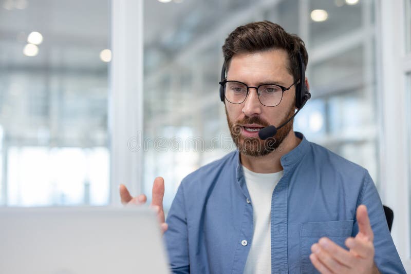 Focused Male Consultant Wearing a Headset, Explaining Something during ...
