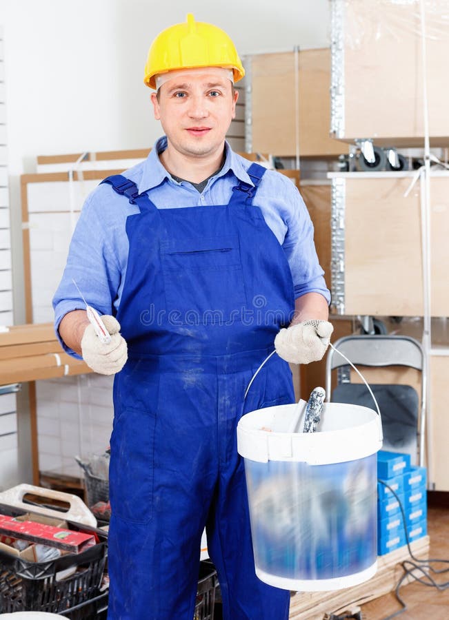 Focused Male Contractor Checking Tools and Materials while Getting ...