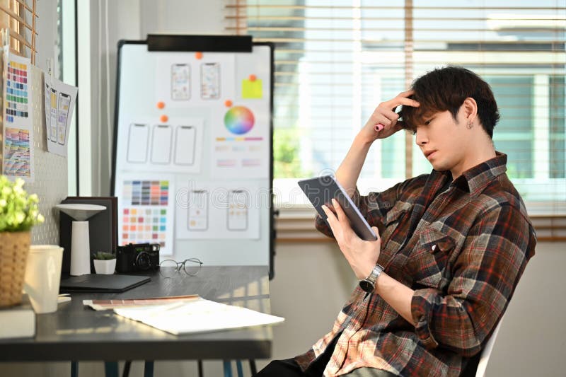 Focused Male UX Designer Using Digital Tablet Working on Mobile App ...