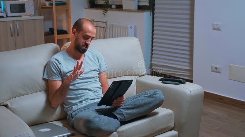 Focused Man with Beard Sitting on Couch in Front of Television Stock ...