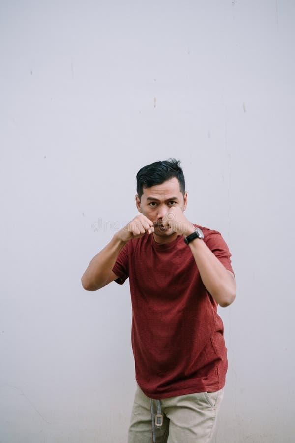 Focused Man in Defensive Boxing Stance Poses Against Plain Background ...