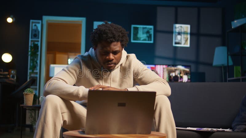 Focused Man Engaged in Online Research for a Work Project at Home Stock ...