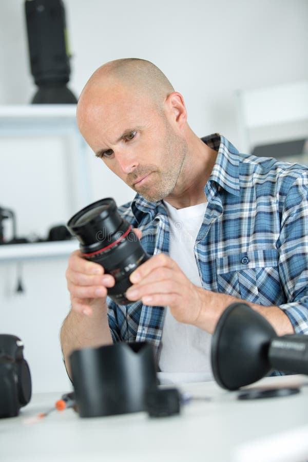 Focused Man Fixing Camera at Workplace Stock Image - Image of ...